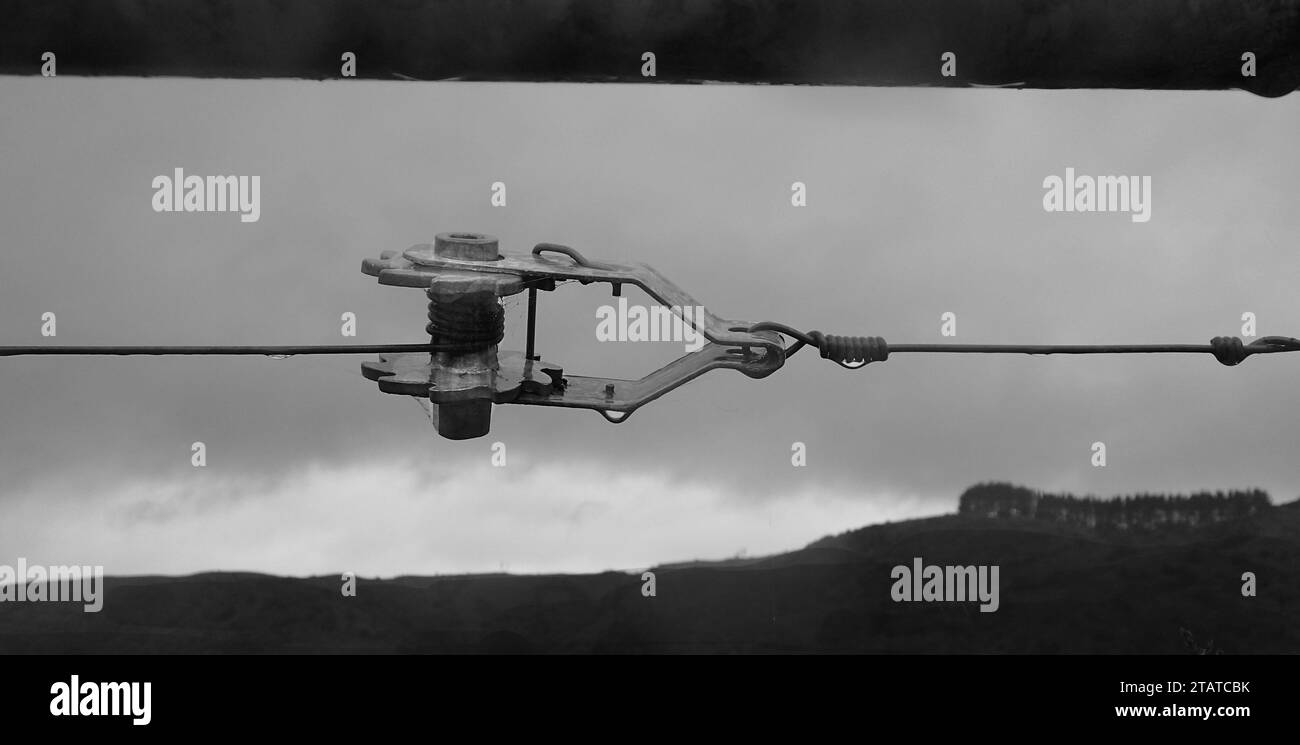 A fence rachet strainer under a horizontal post and under tension, with ...