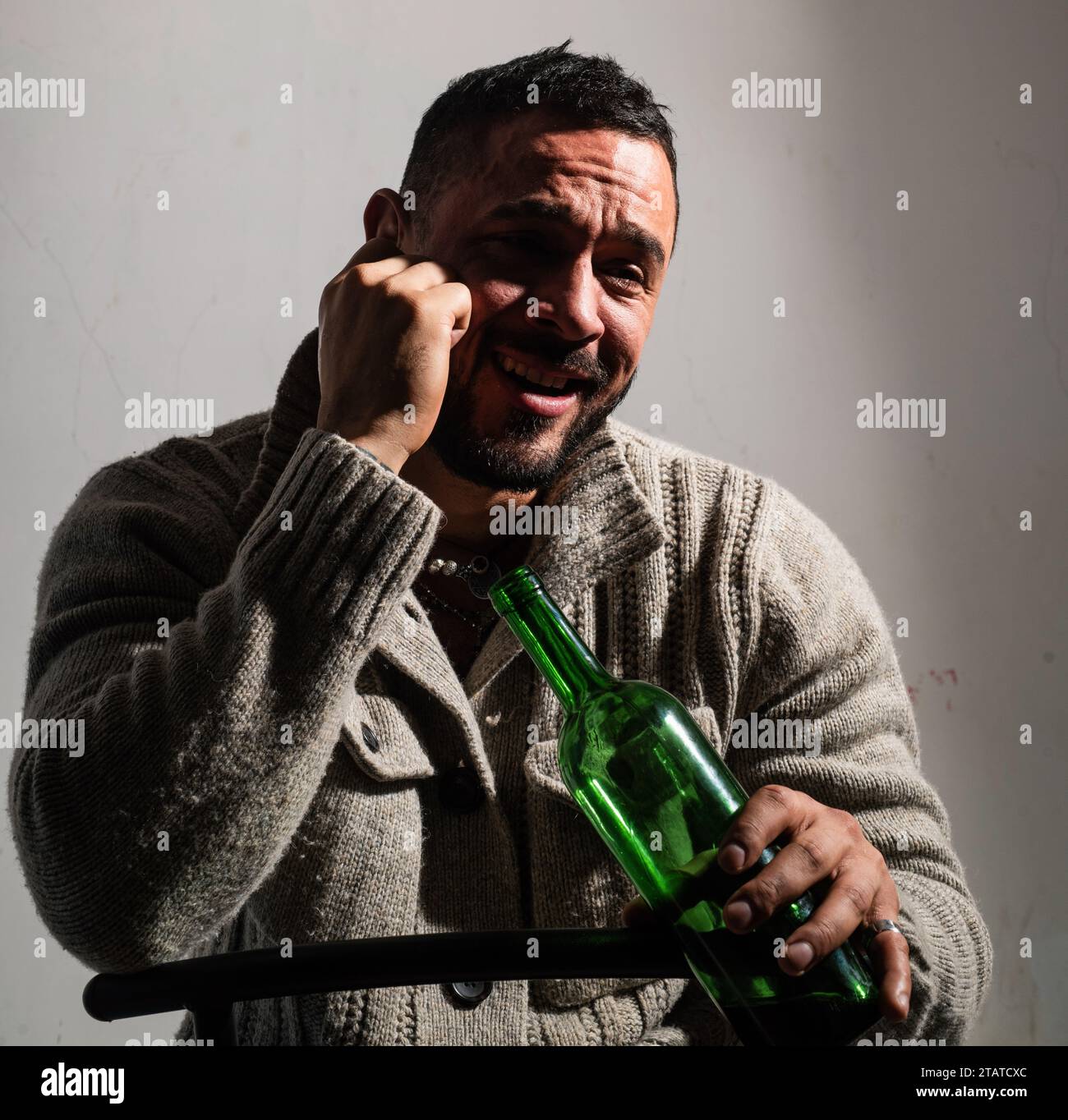 Drunk man drinking wine. Depressed guy with bottle alcohol, sad and ...