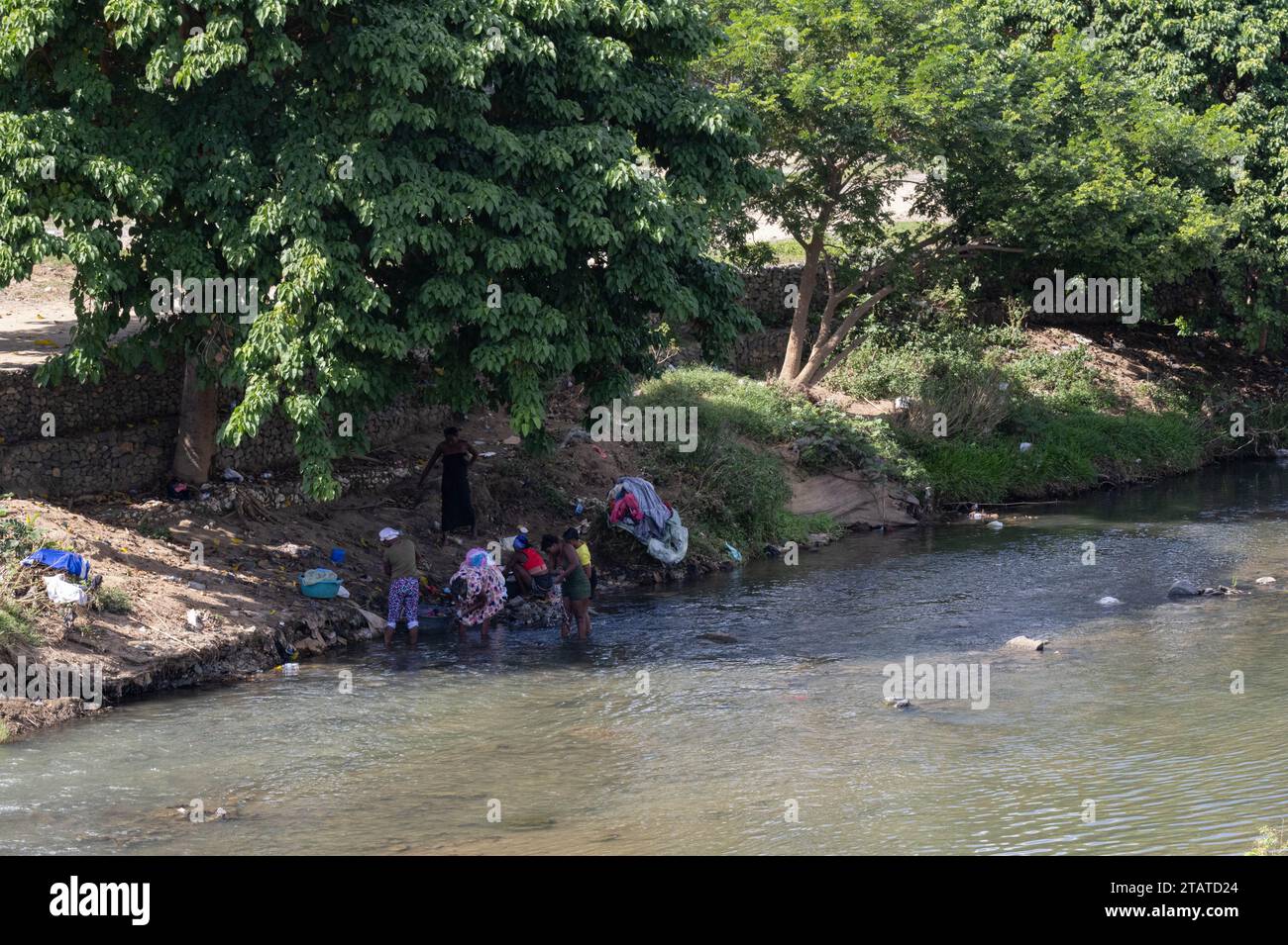 Haitians wash their clothes on the Haitian side of the Massacre River ...