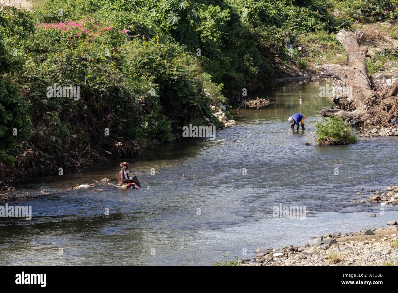 Haitians wash their clothes on the Haitian side of the Massacre River ...