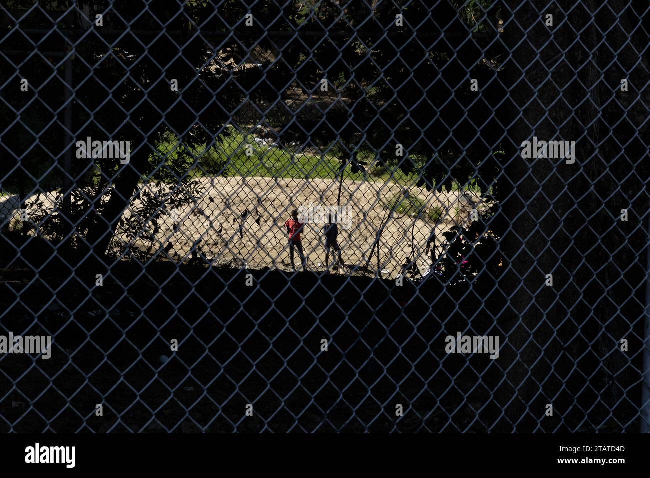 Haitians stand on the edge of the Massacre River past the Dominican ...