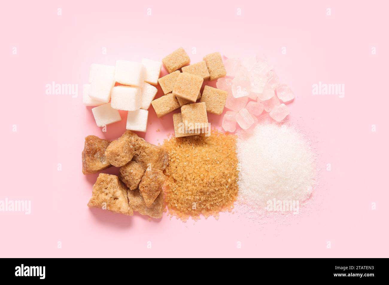 Different types of sugar on pink background Stock Photo - Alamy