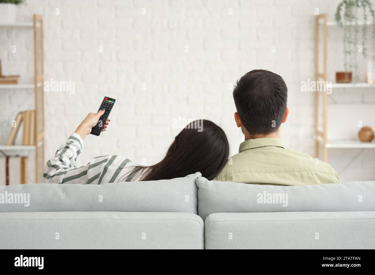Back view of family watching television hi-res stock photography and ...