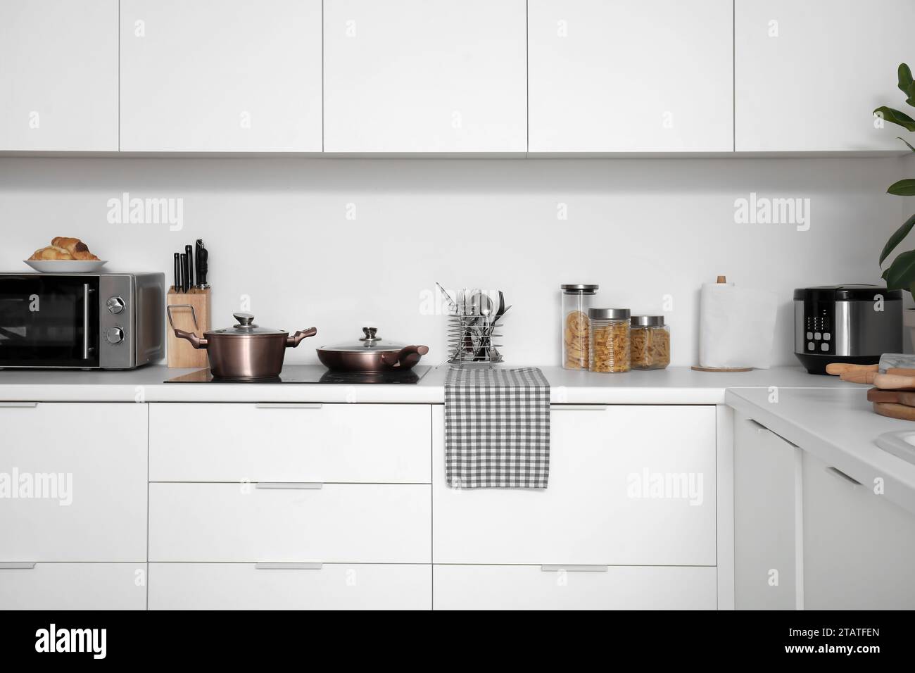 Modern electric stove with kitchenware Stock Photo - Alamy