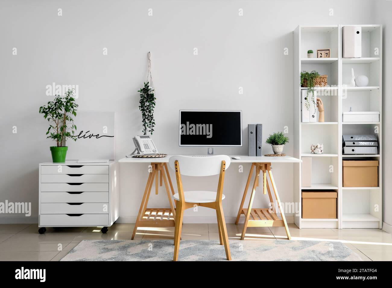 Interior of light office with workplace, shelf unit and drawers Stock ...
