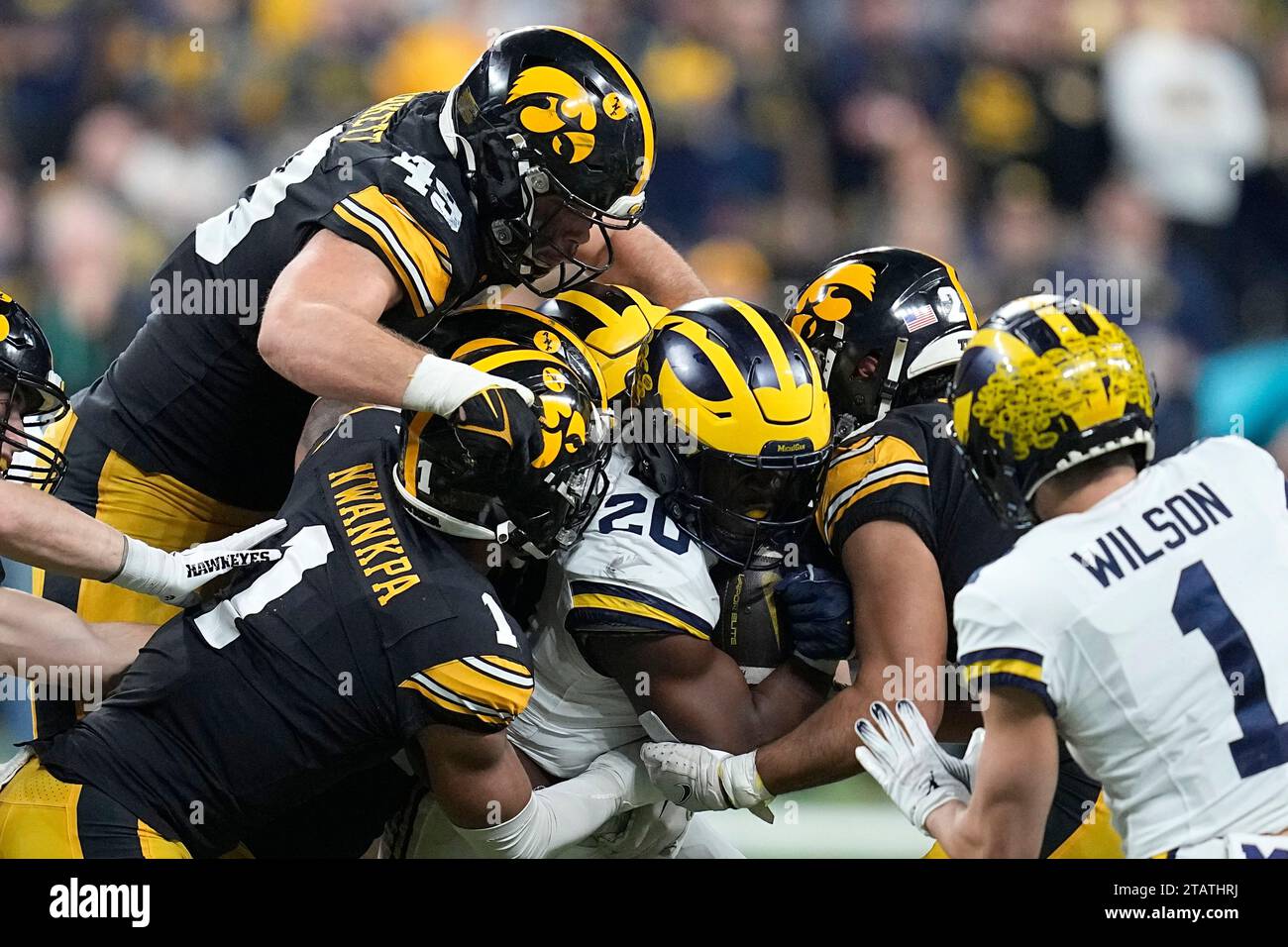 Michigan running back Kalel Mullings (20) is tackled by Iowa defenders ...