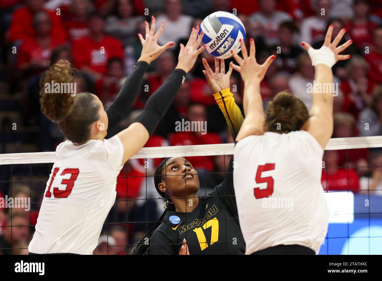 Missouri's Naomi Franco (17) hits the ball between Nebraska's Merritt ...