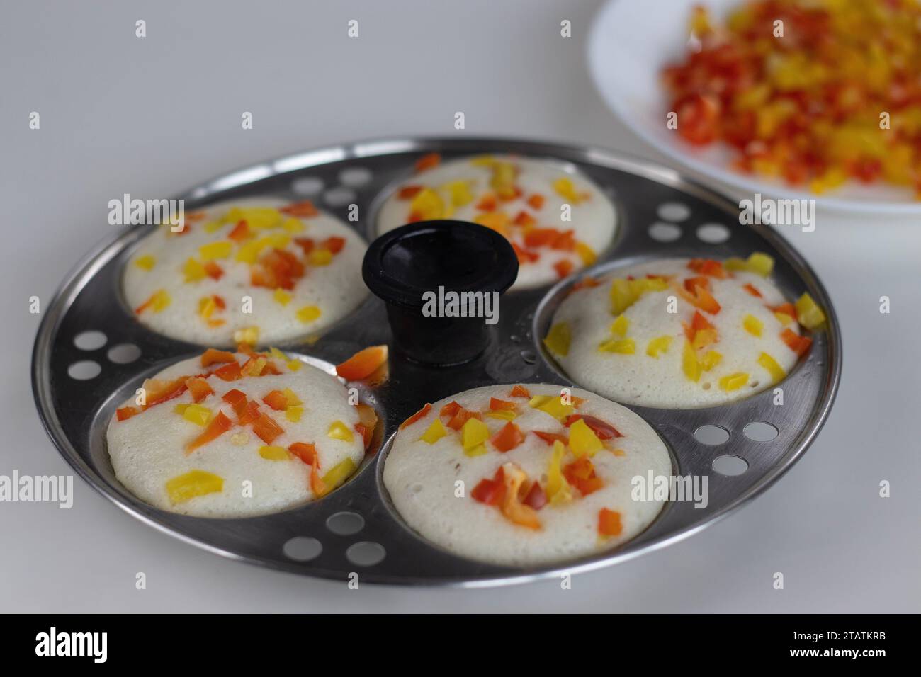 Savory bell pepper idly in idli mould, a colorful and appetizing South ...