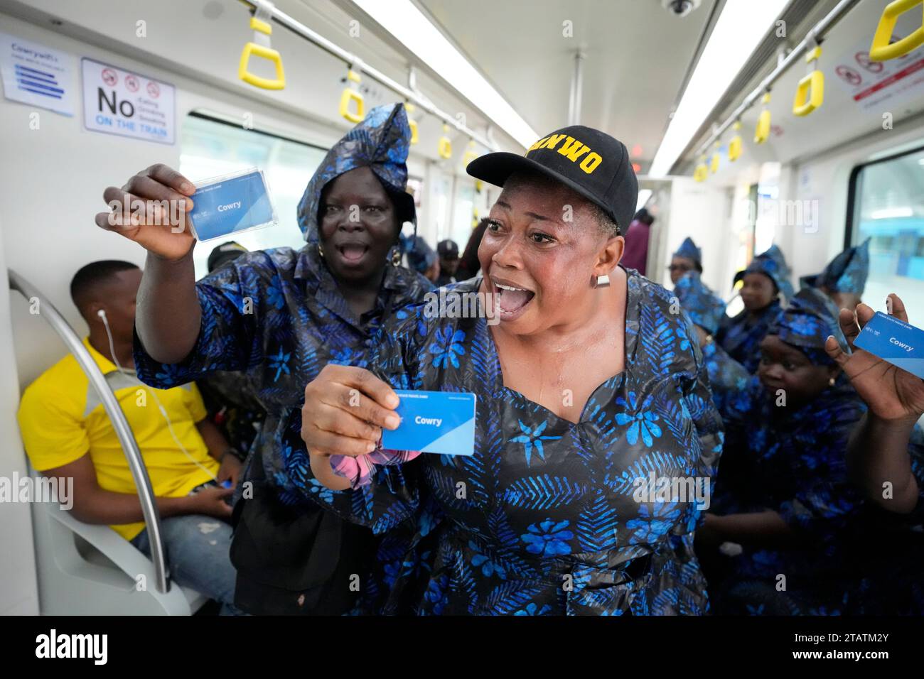 People sing as the ride on a new Lagos blue line train service in Lagos ...