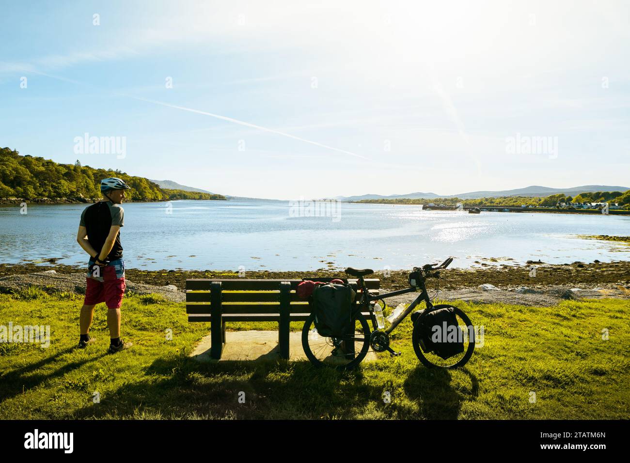 Male cyclist stand by bicycle rest in scenic nature by lake relax enjoy ...