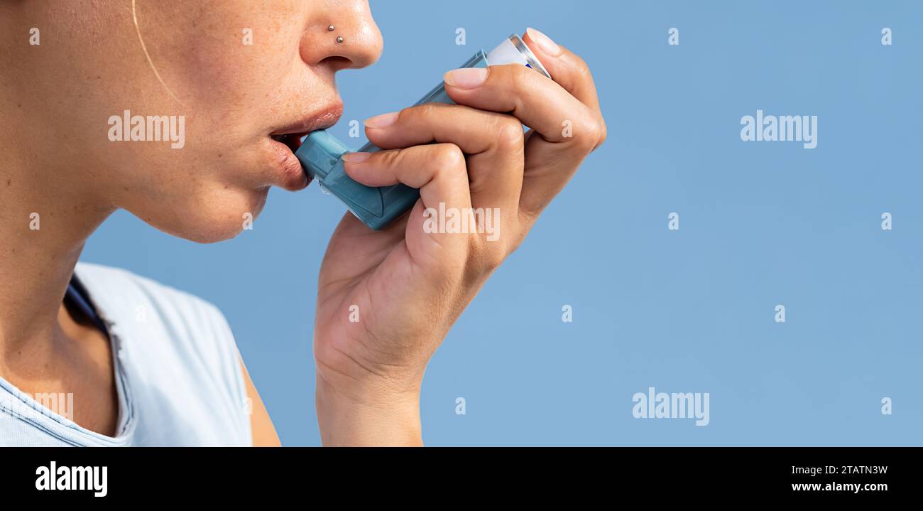 Woman using asthma inhaler during asthma attack Stock Photo - Alamy