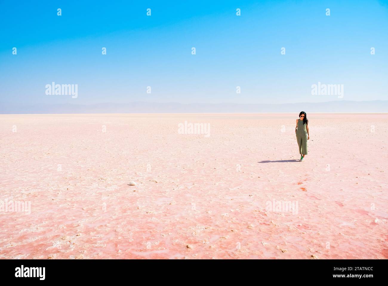 Aerial view young caucasian woman alone walk and explore maharlu salt ...