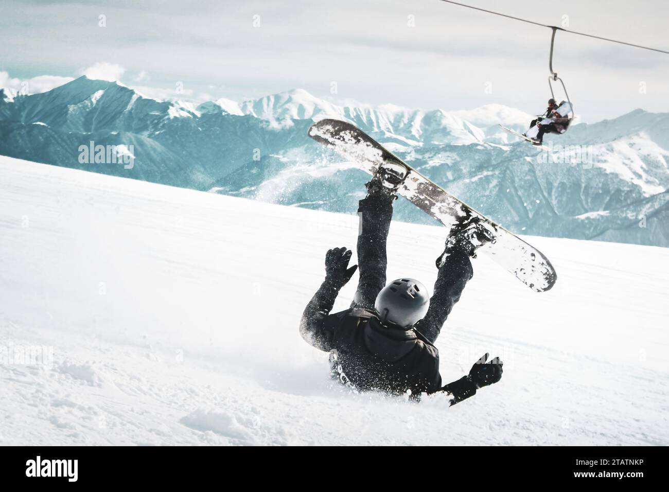 Snowboarder fall down on back painfully with snow splashes on snowy off ...