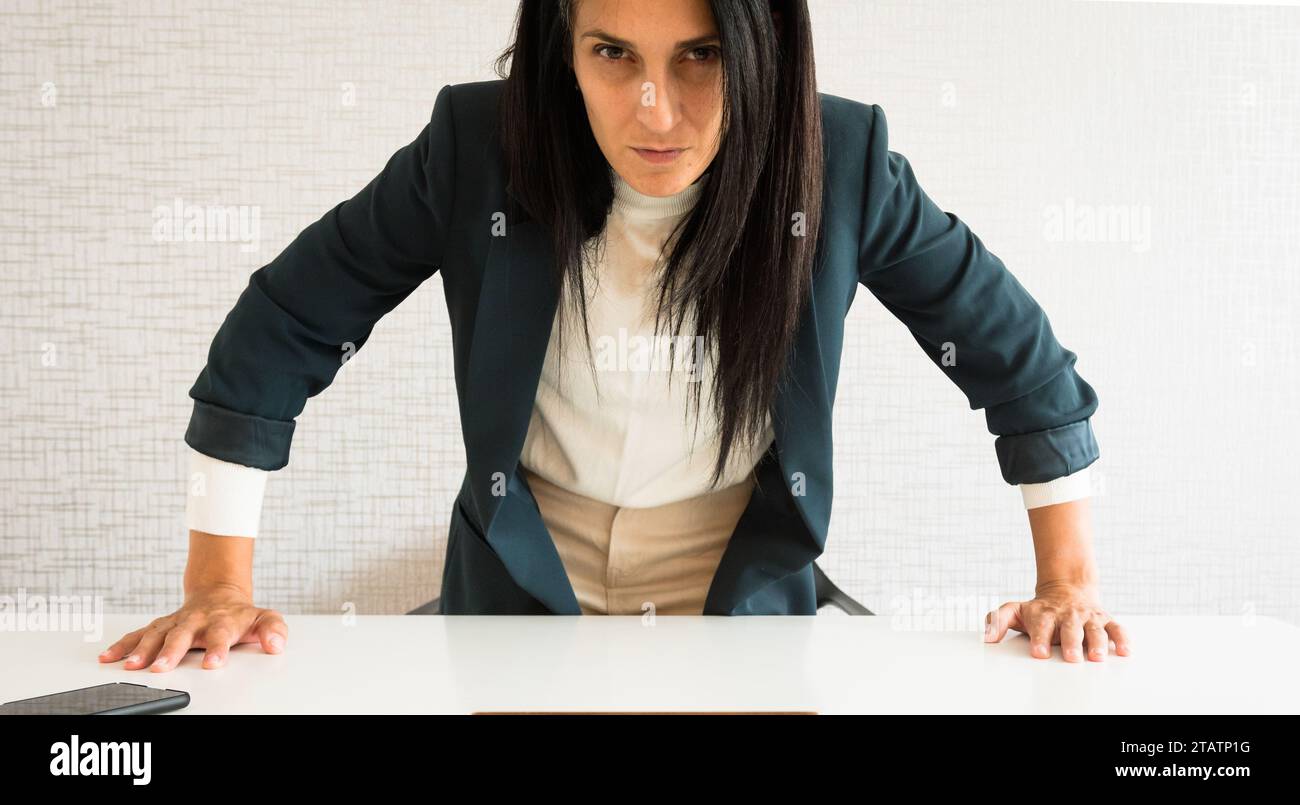 Young caucasian brunette business woman director in office stand up ...