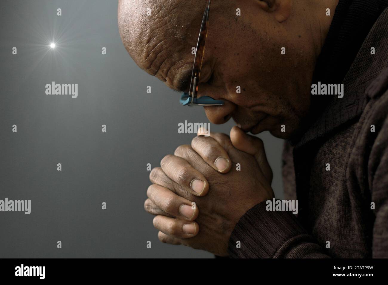 man praying to god on gray black background with people stock image ...