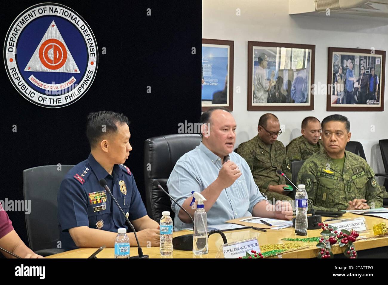 Philippine Defense Secretary Gilbert Teodoro, center, talks beside ...