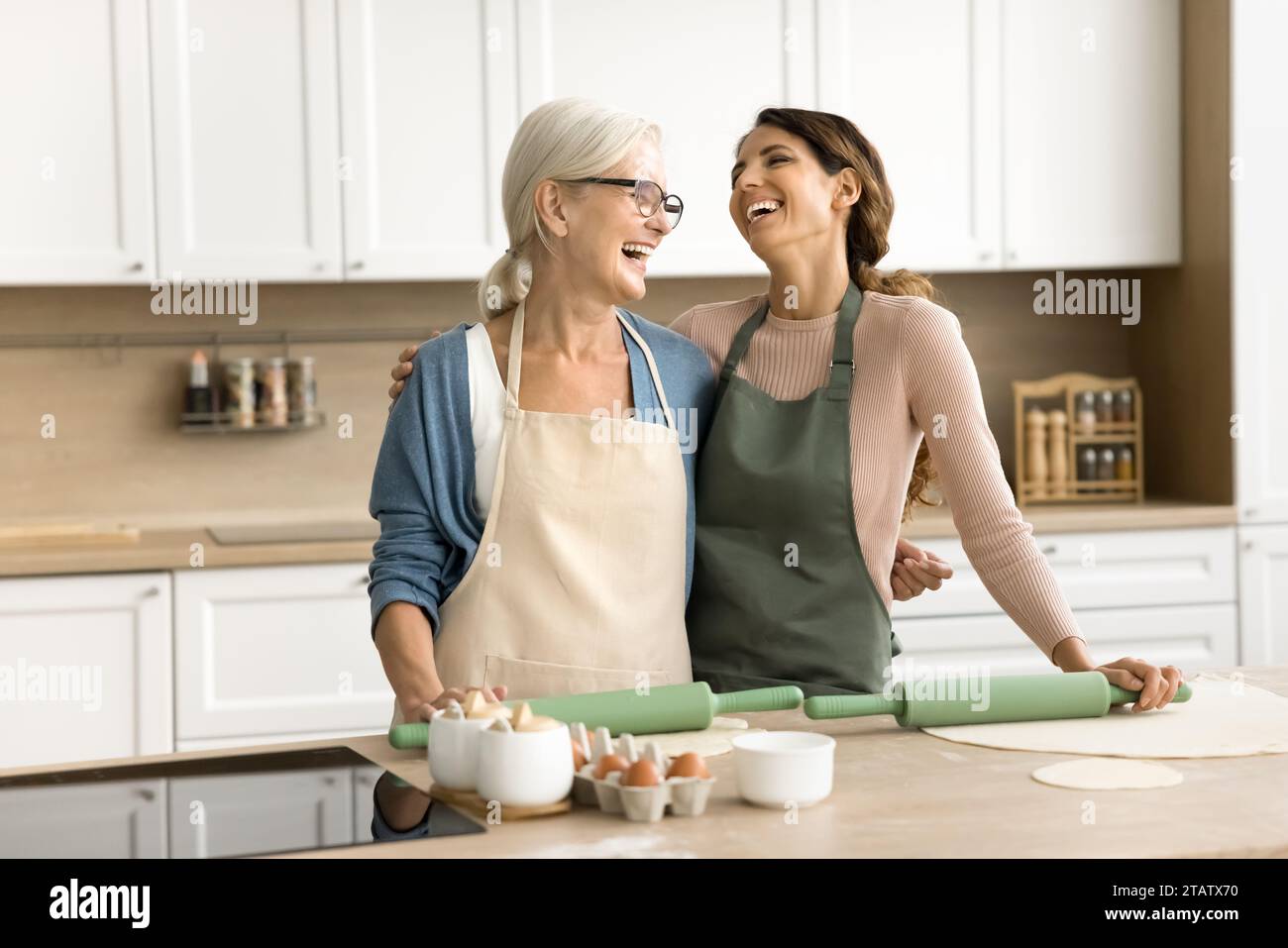 Happy excited mature mom and adult daughter woman wearing aprons Stock ...