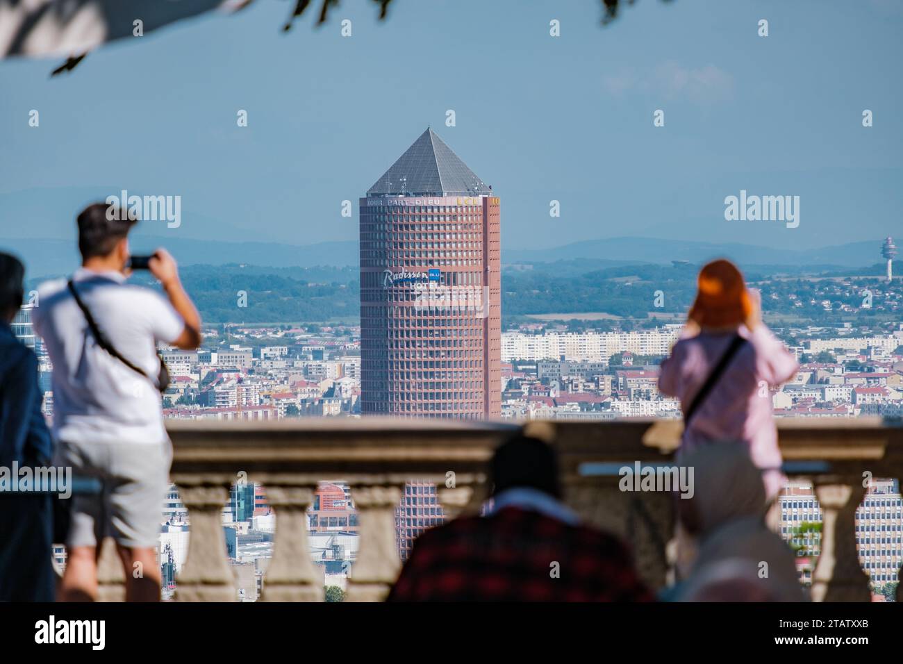 Tourists taking photos of the famous Part-Dieu Tower, nicknamed 'le ...