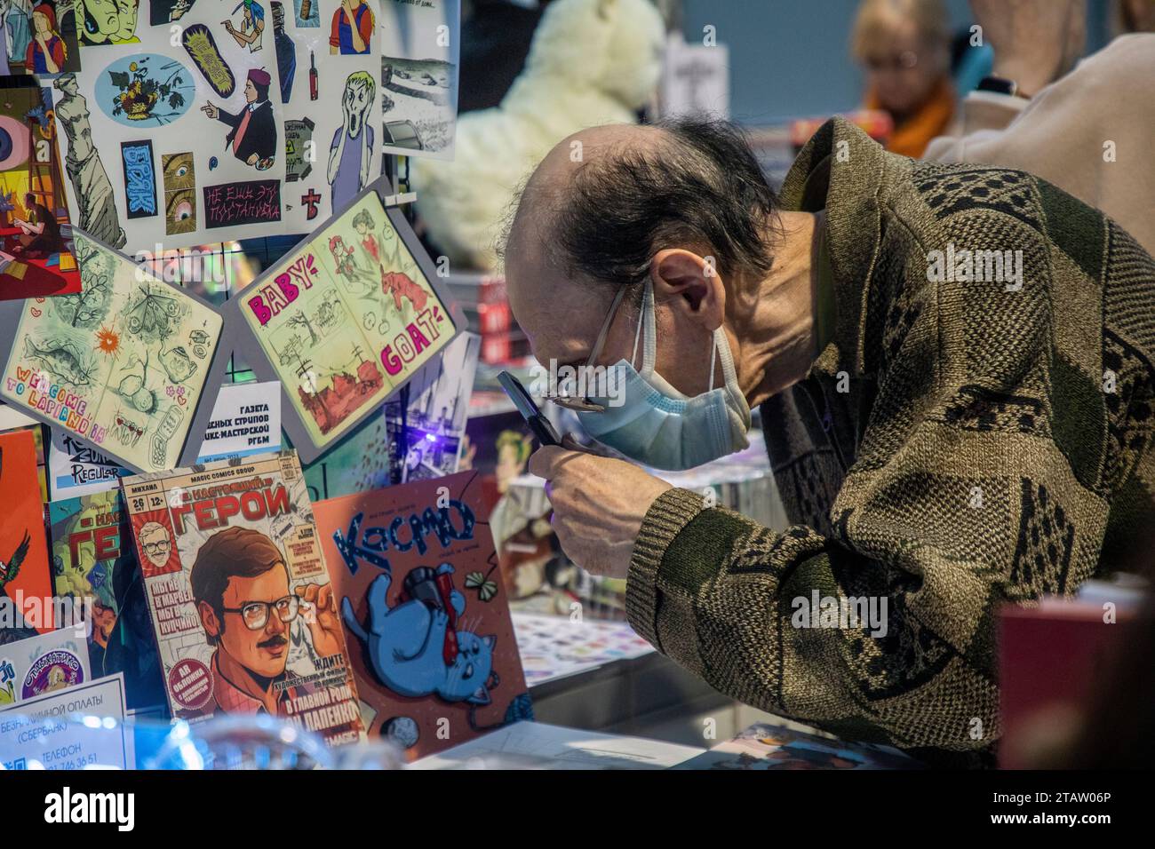 Moscow, Russia. 2nd of December, 2023. Old man watches comics at a ...