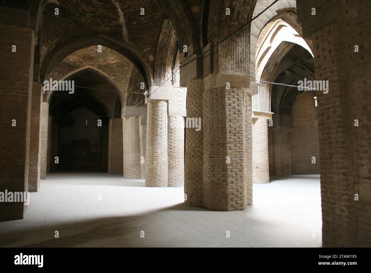 An interior shot of an airy and open space with stone columns on each ...