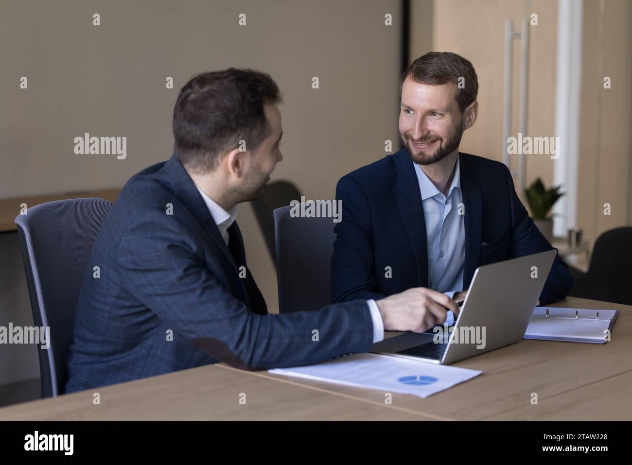 Two businessmen partners in formal suits met discuss joint project ...