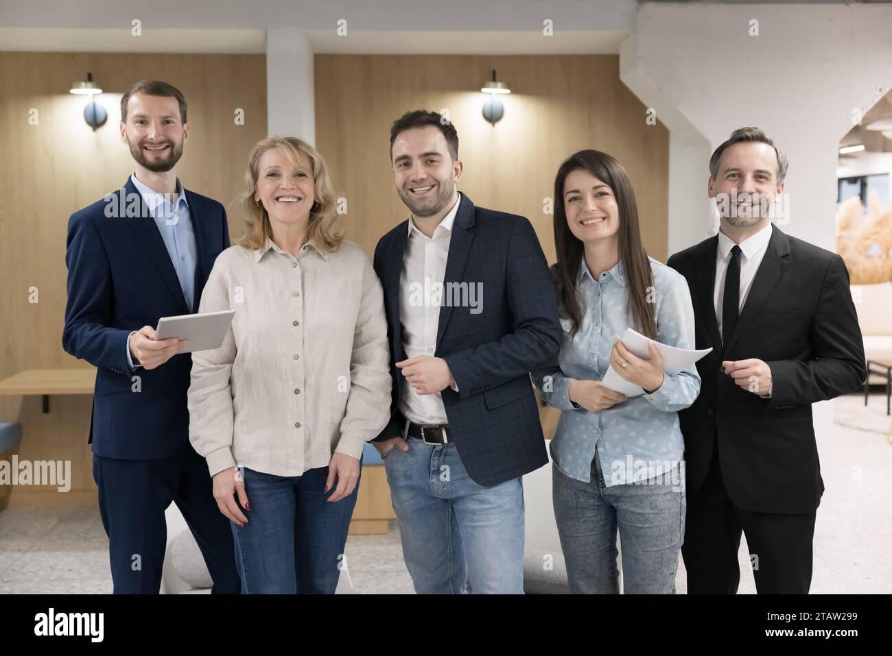 Corporate employees posing in modern office smile look at camera Stock ...