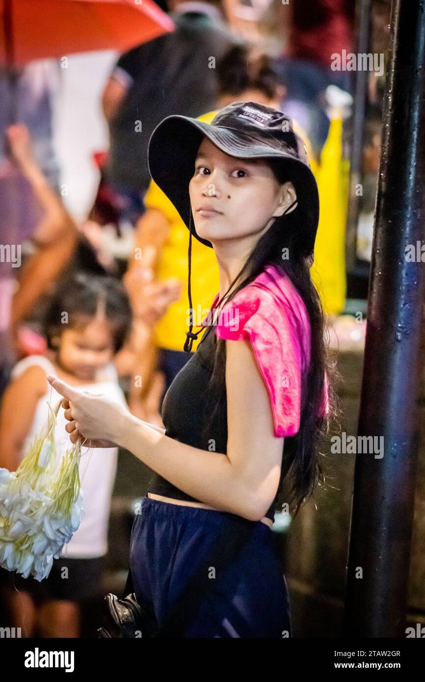 A pretty young Filipino girl sells flower garlands at Santo Nino de ...