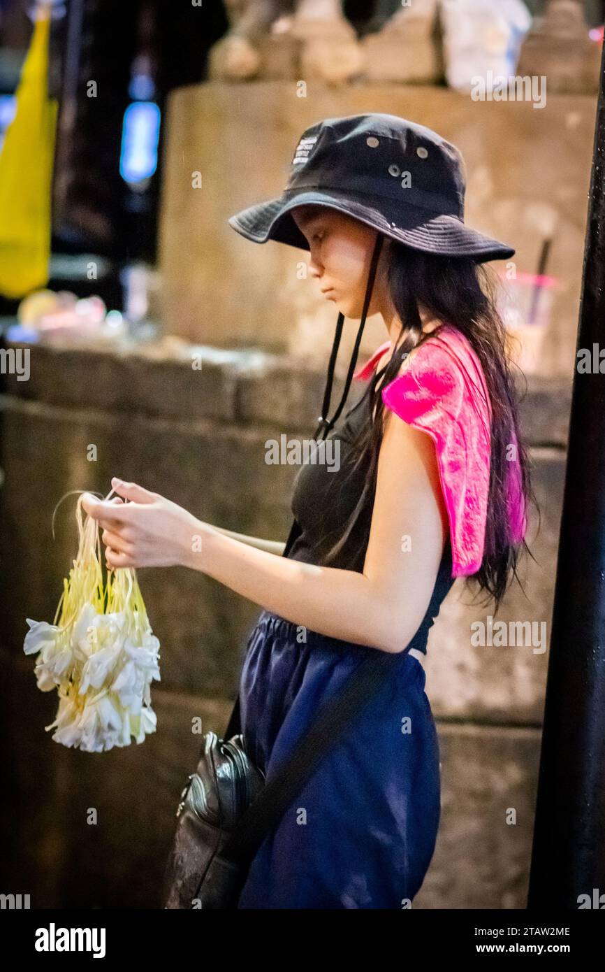 A pretty young Filipino girl sells flower garlands at Santo Nino de ...