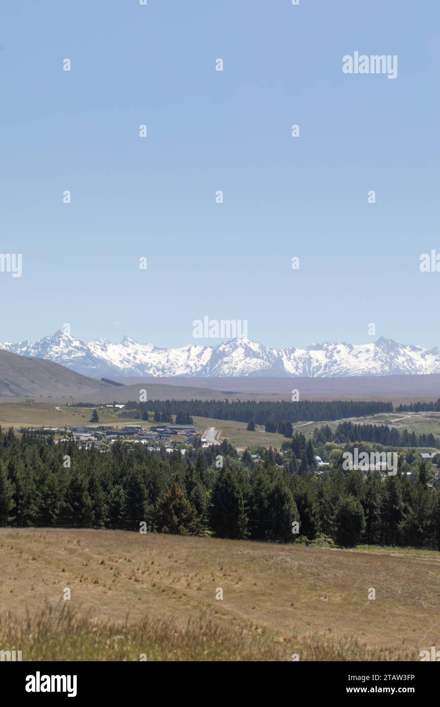 A beautiful landscape of snowy mountains and a village in the valley of ...