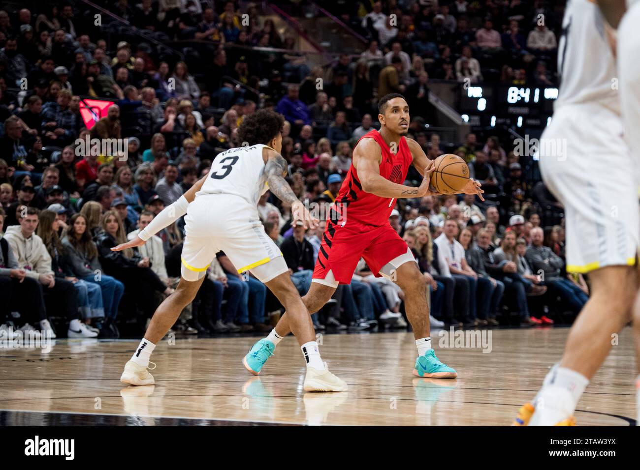 Portland Trail Blazers guard Malcolm Brogdon, right, passes while ...