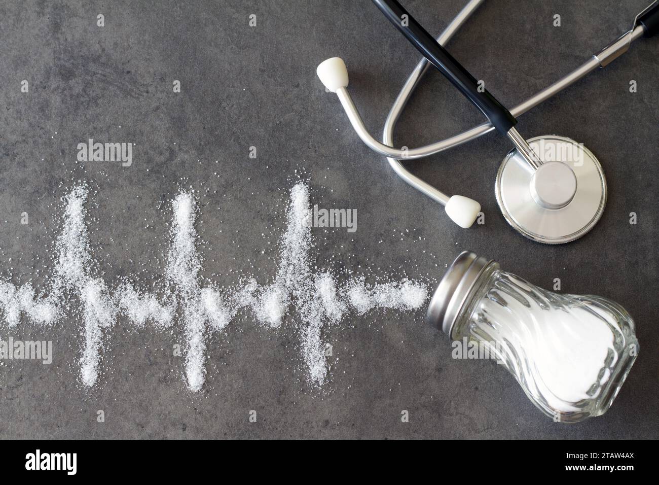 Salt shaker, stethoscope, cardiogram made of salt, hypertension concept ...