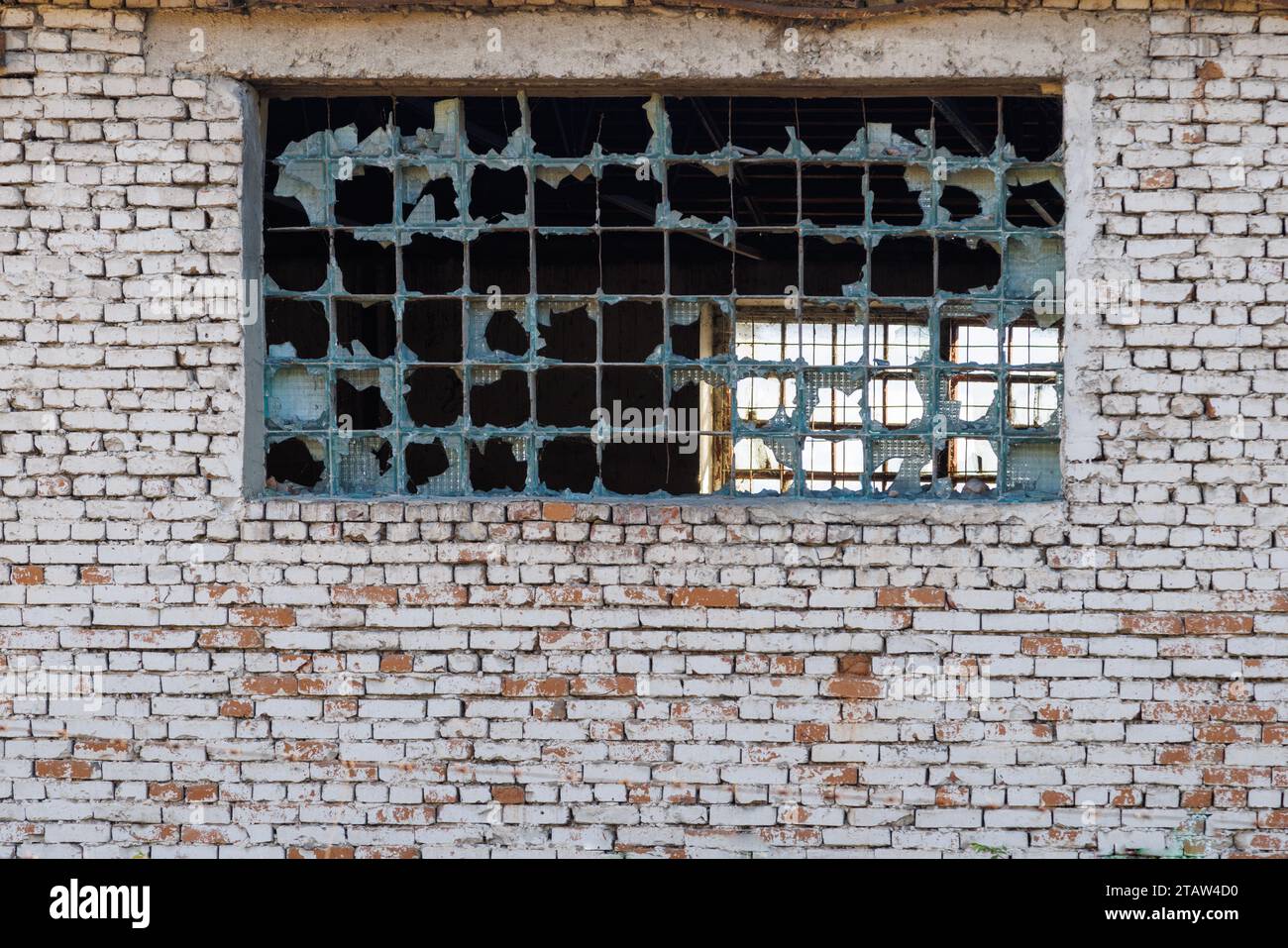 broken glass block window in white brick wall texture and background ...
