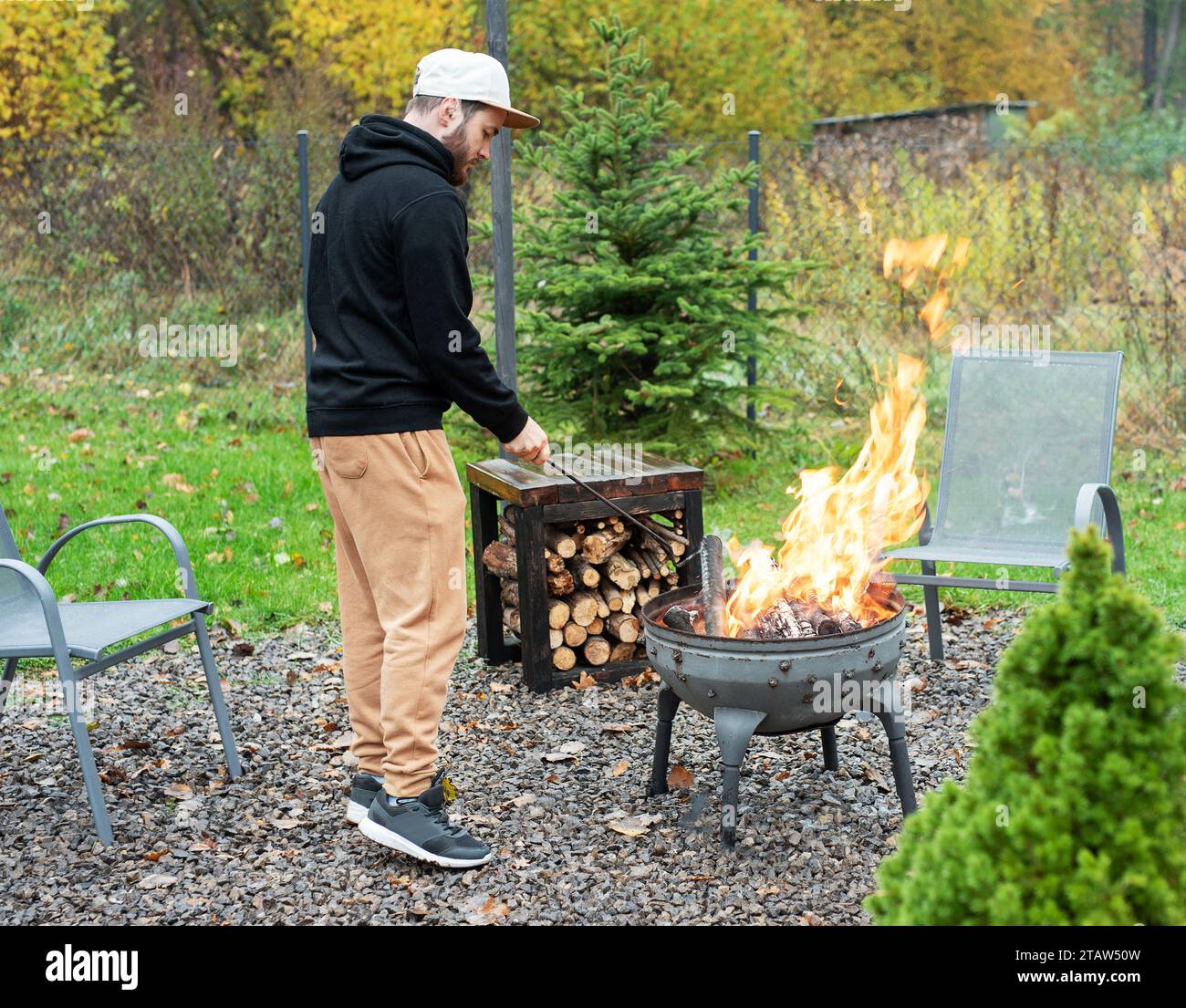 Young man lights fire in hi-res stock photography and images - Alamy