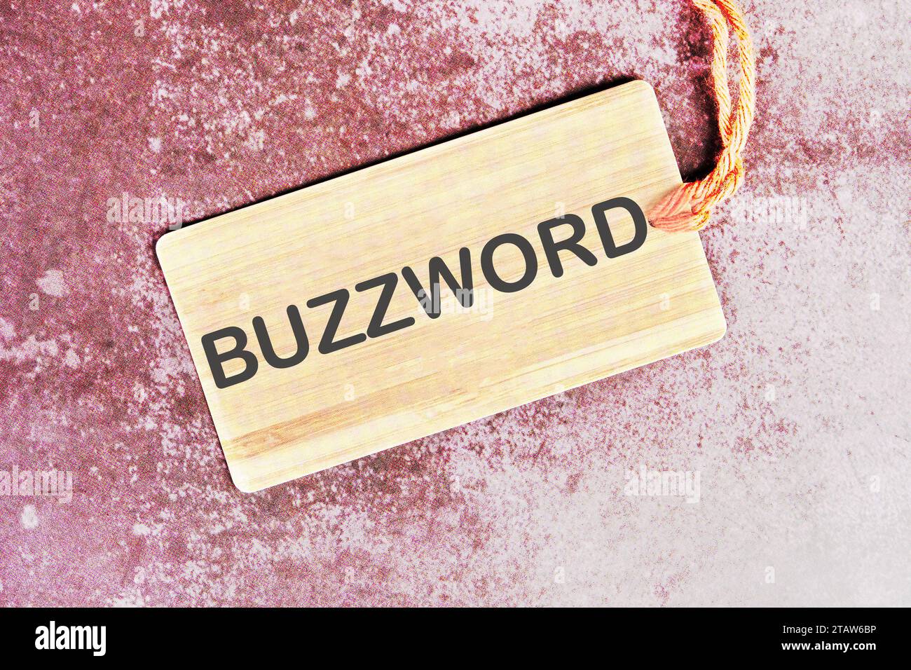 Buzzword word written on a card with a rope on an abstract background ...