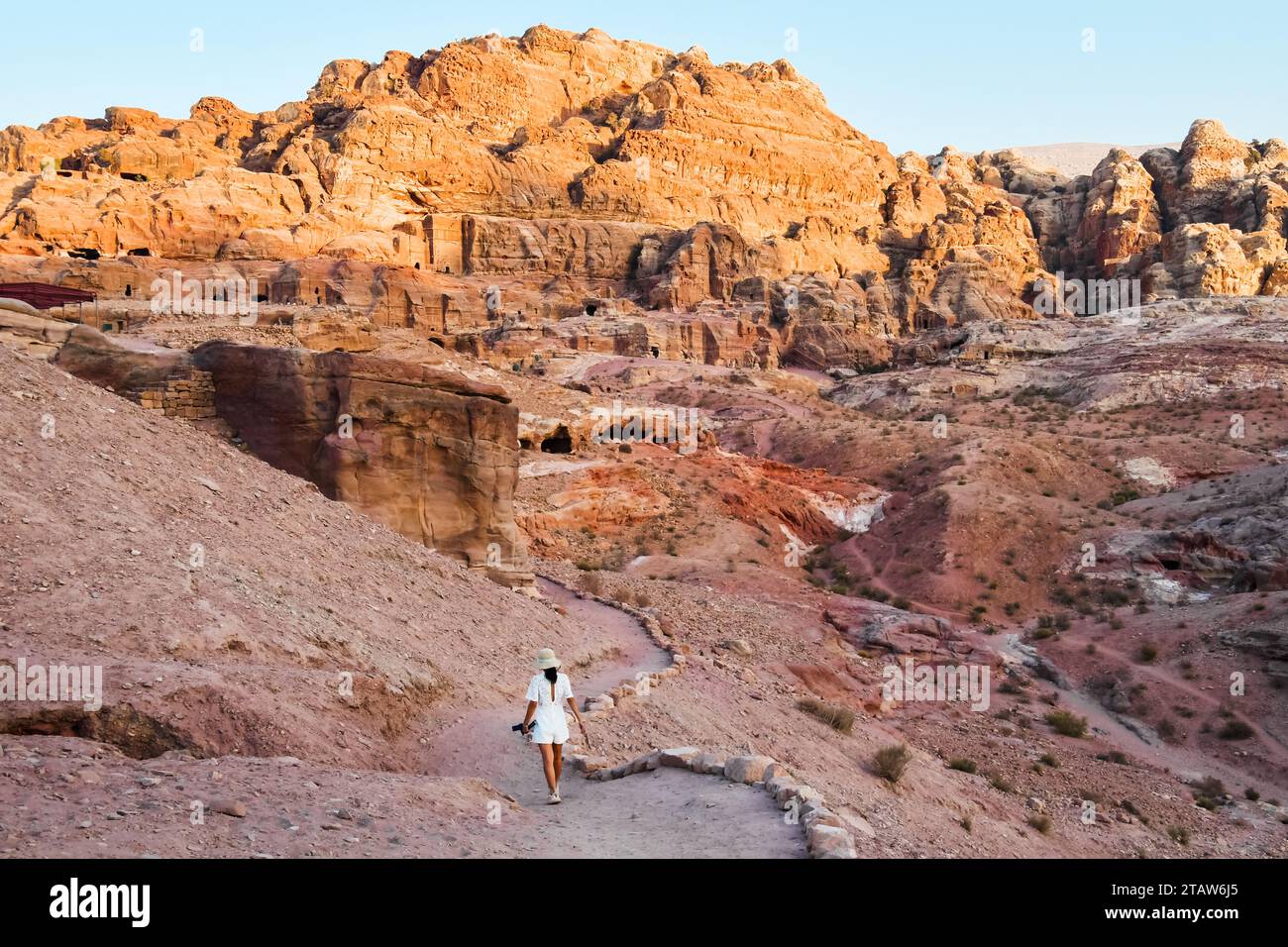 Female Tourist blogger in white dress walk explore around Petra ruins ...