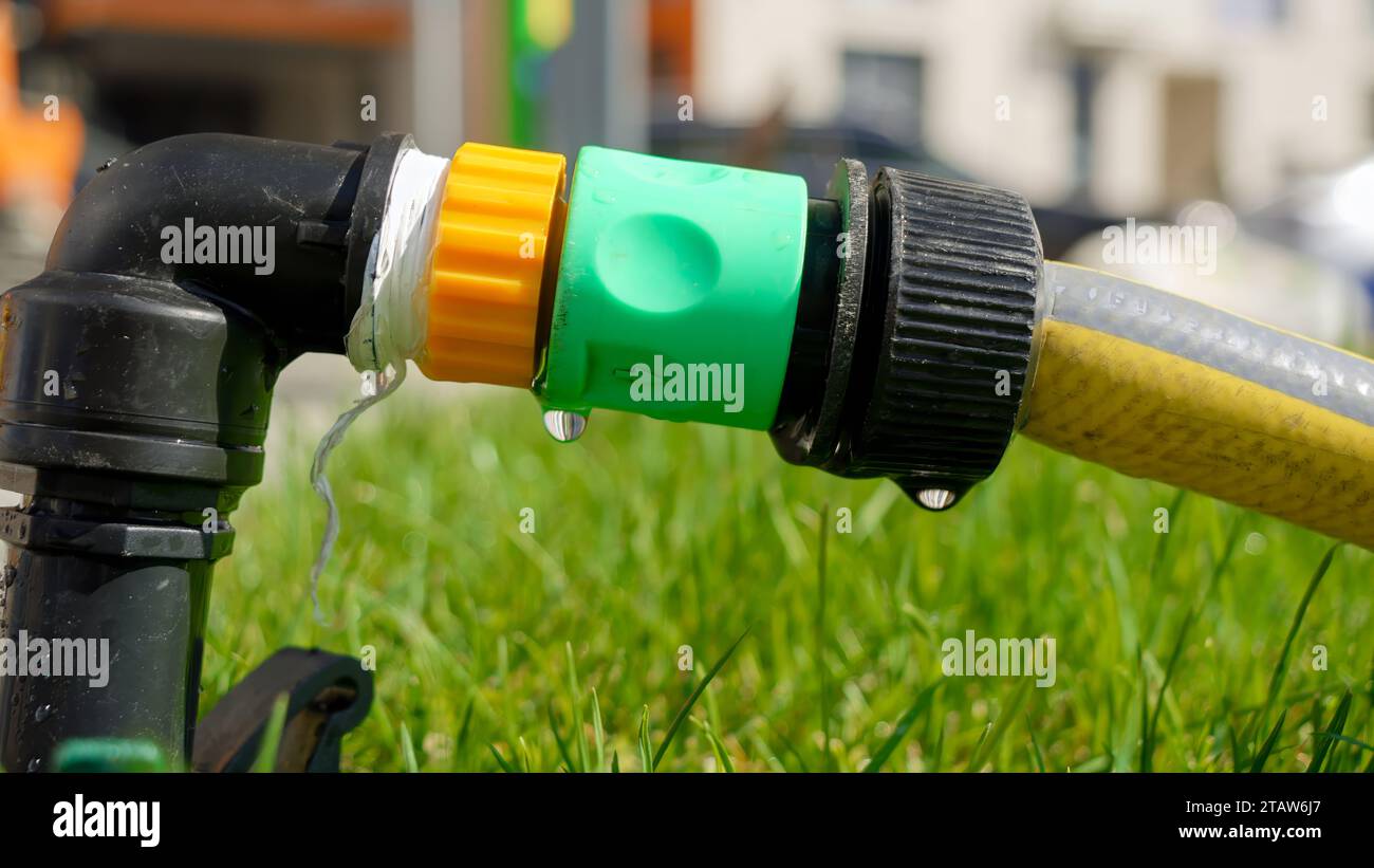 Water droplets leaking through damaged water hose pipe connection ...