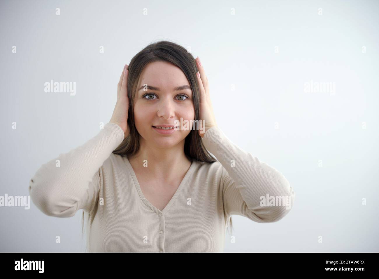Girl Is Surprised She Holds Two Hands On Her Head Look Into The Frame