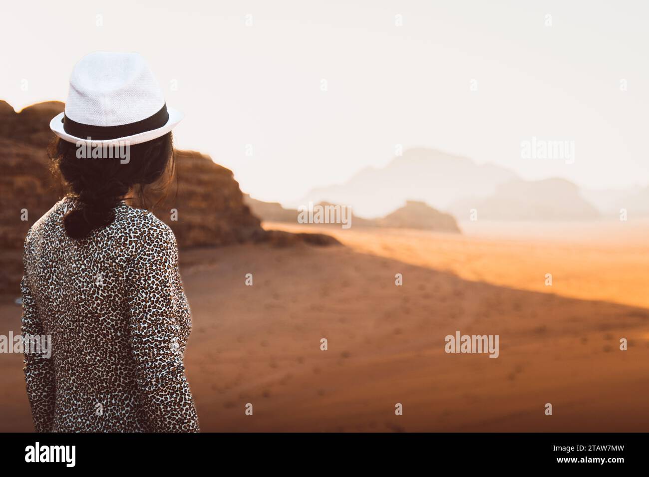 Woman tourist stand on cliff at viewpoint enjoy Wadi rum panorama on ...
