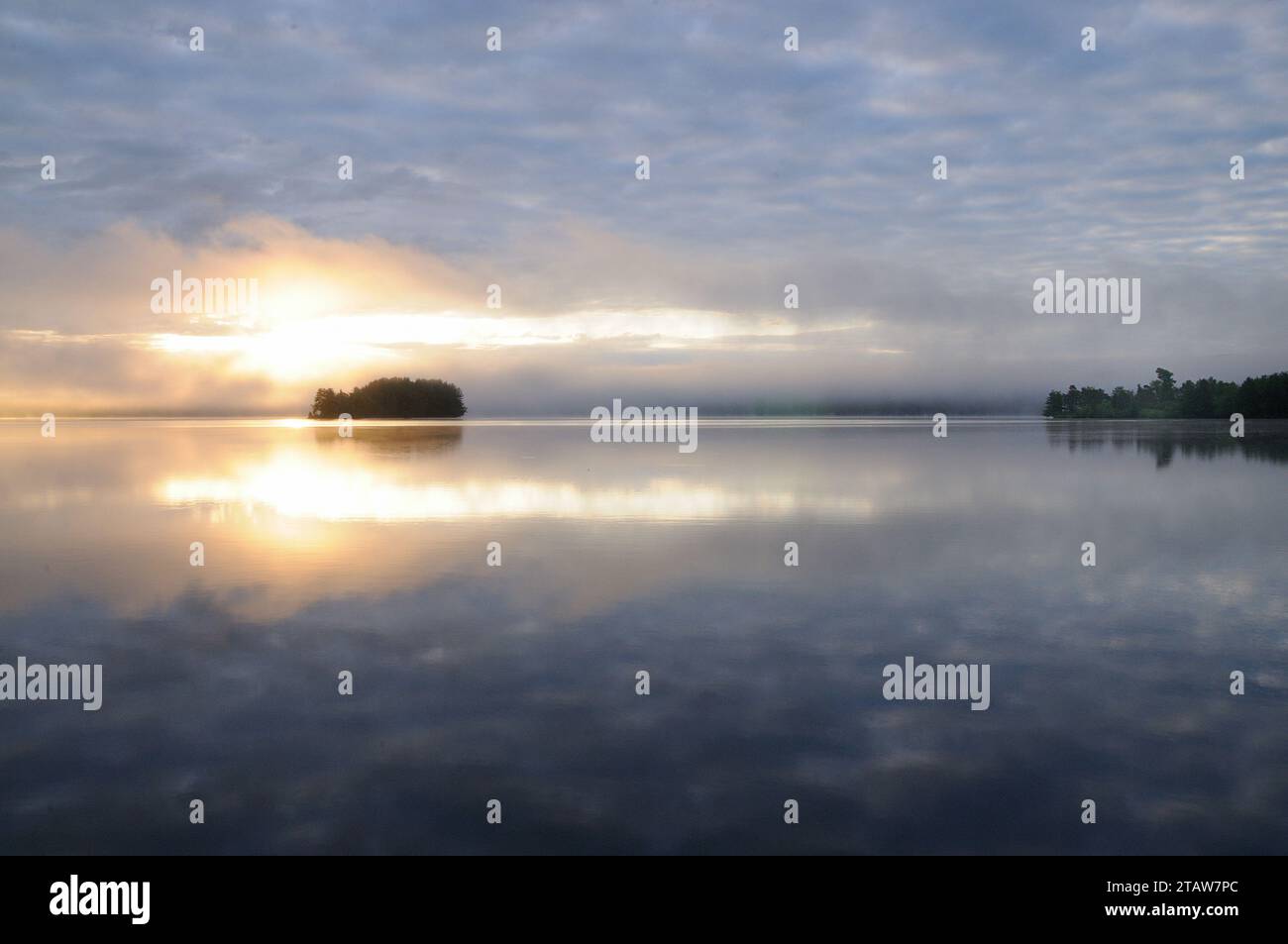 Reflection in the water at sunrise Stock Photo - Alamy
