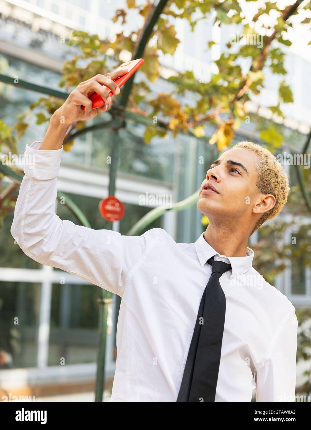 Beautiful young black guy smiling and modern taking a selfie in the ...