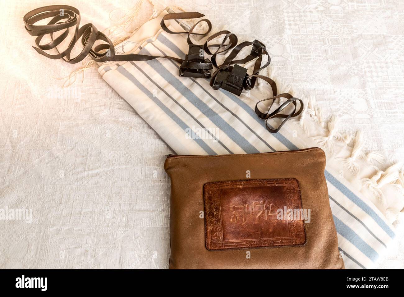 A set of tefillin with verses from Torah written in them and a pouch ...