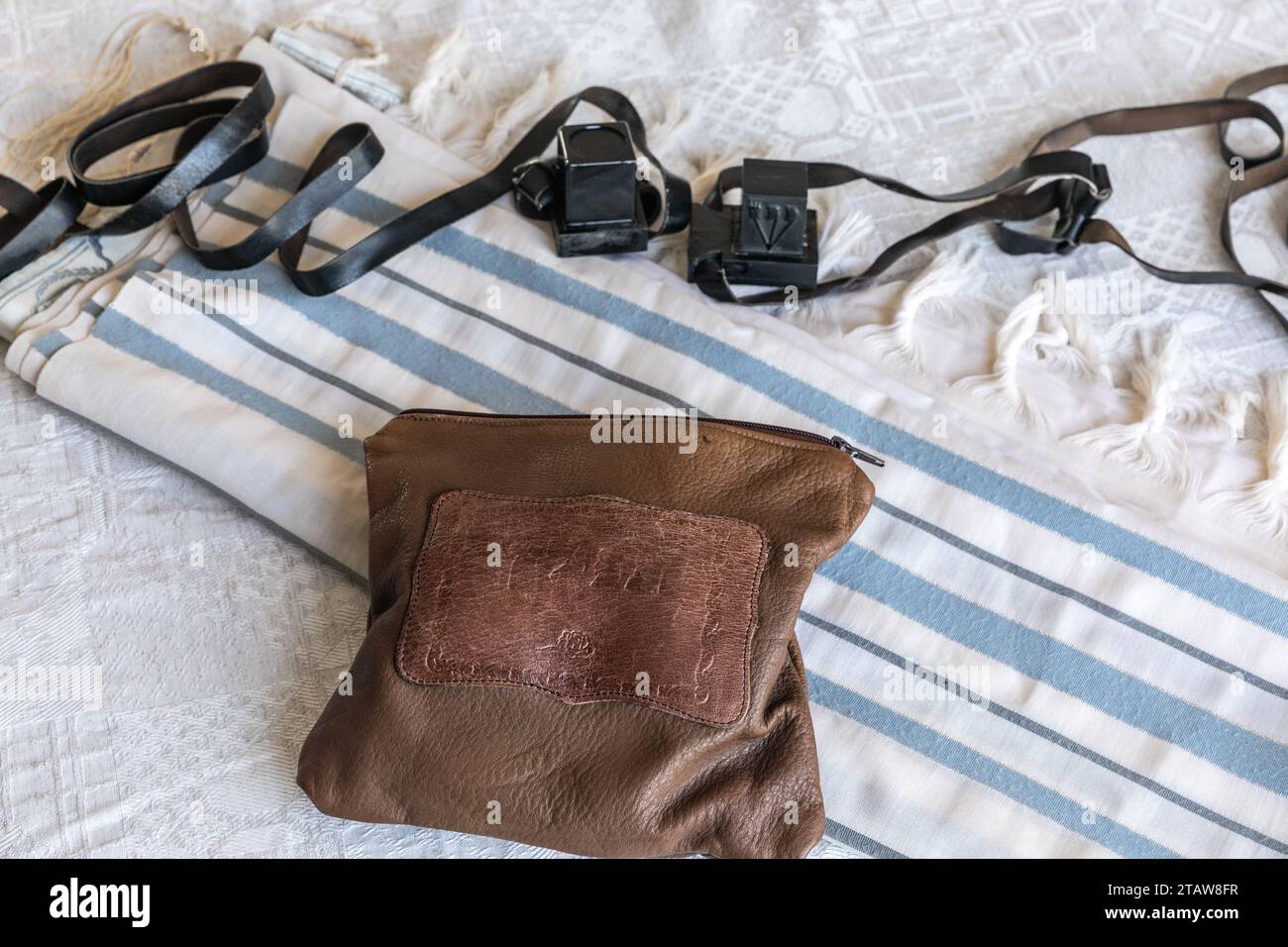 A set of tefillin with verses from Torah written in them and a pouch ...