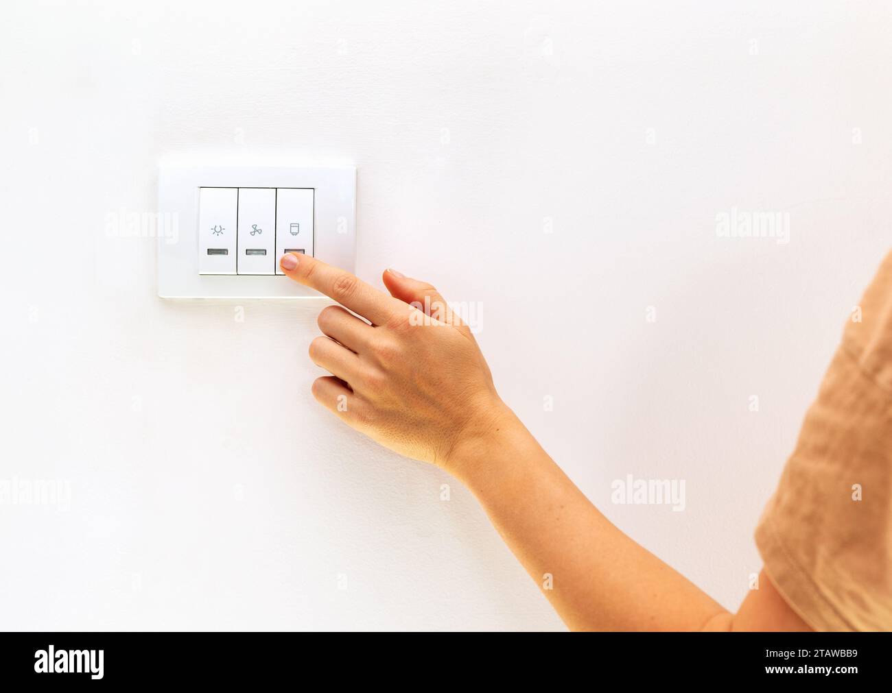 Reduction in electricity consumption. Female finger on light switch ... Reduction in electricity consumption. Female finger on light switch ...