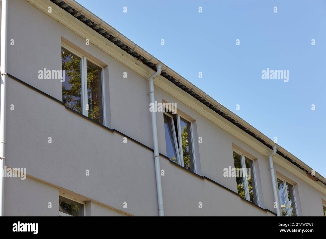 Facade of a building with downspout. Guttering and drainage pipe ...