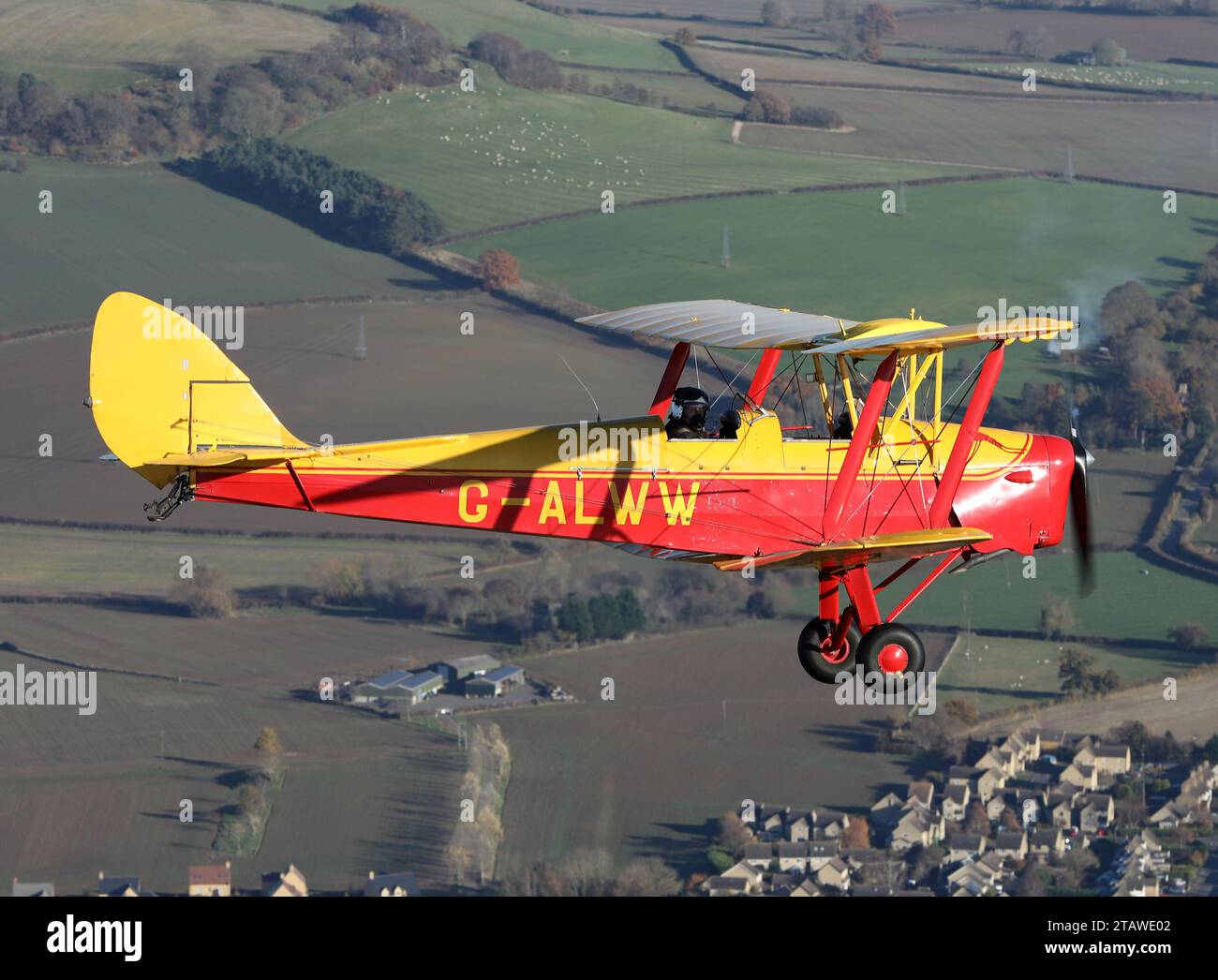An old 1943 DH82A Tiger Moth in the skies over Warwickshire Stock Photo ...