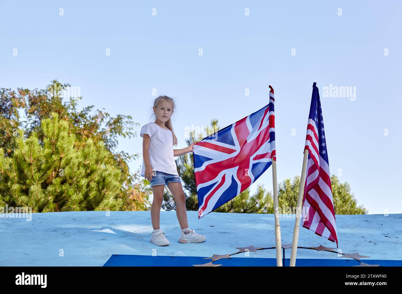 Beautiful little girl with big Britain flag in her hand. Adorable ...