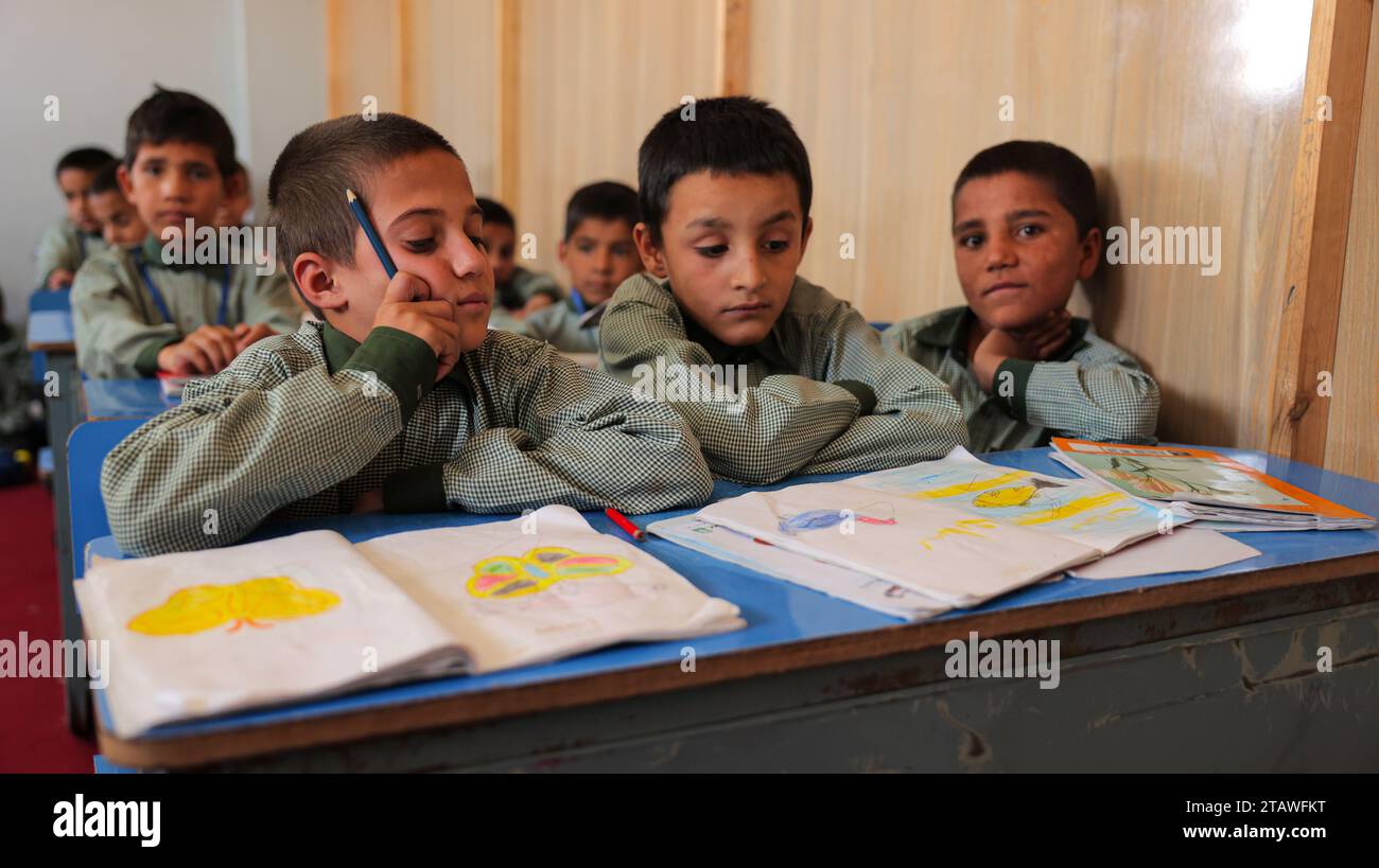 Education in Afghanistan: Schools in impoverished countries, schoolboys in a classroom in an ...