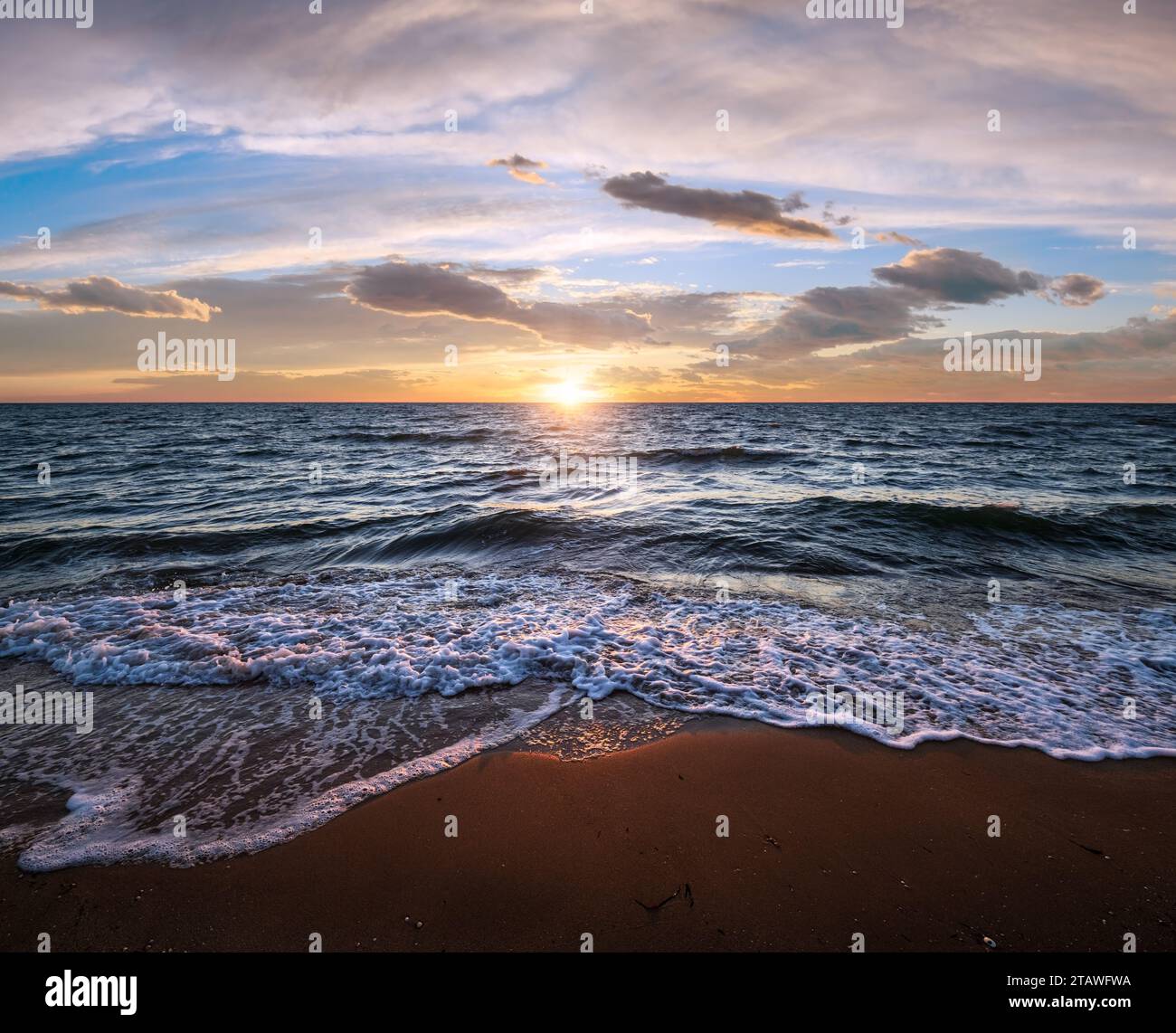 Colorful sea beach sunrise with clear morning sky and sun over horizon ...