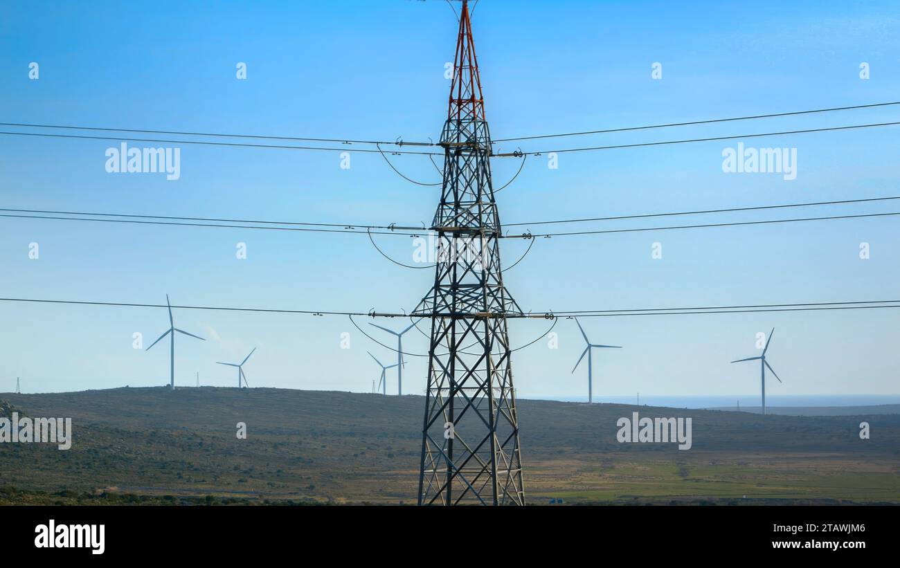 High voltage power line against rotating windmill wind turbines in ...