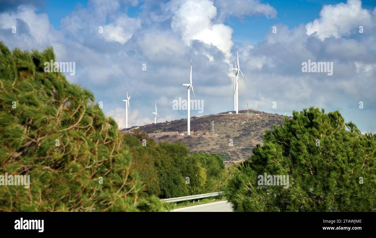 Windmill electric power turbines rotating on the high hill next to ...